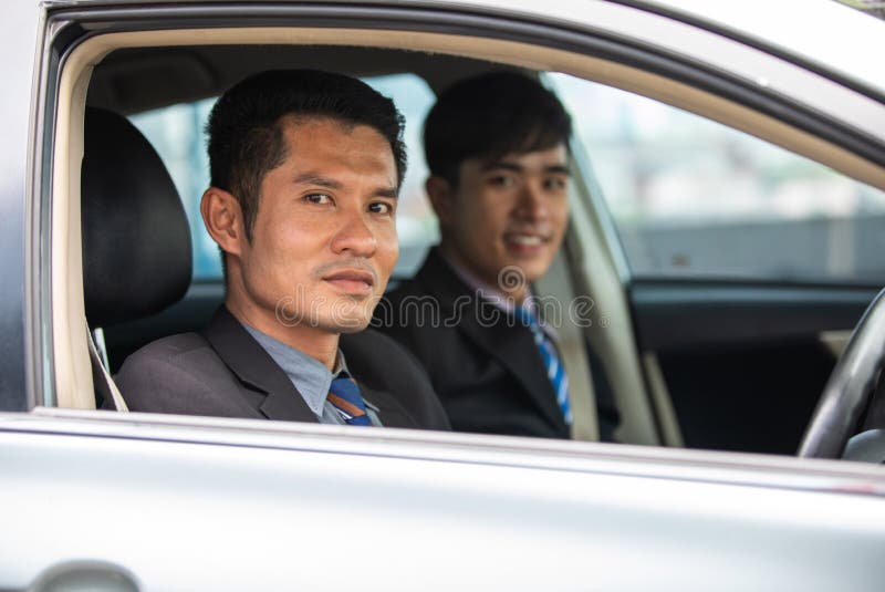 Two Business Men are Driving and Looking Out of the Car Window Stock ...