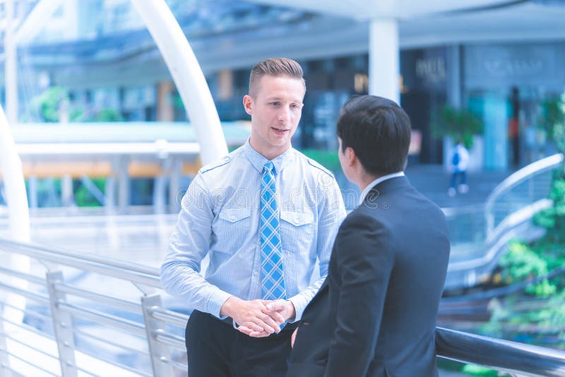 Business Men are Talking in an Outdoor Train Station Stock Photo ...