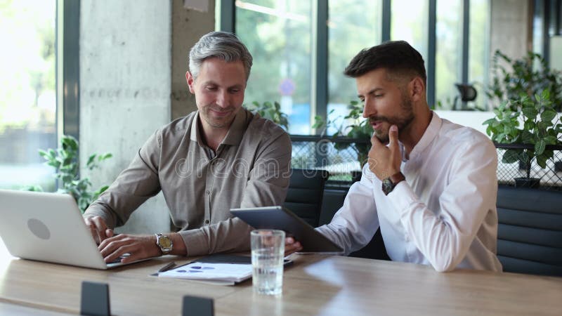 Two Business Men Talking To Each Other Discussing Their Business ...