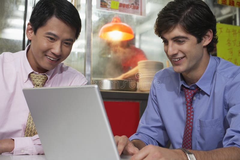 Two Business Men Using Laptop in Bar Stock Photo - Image of japanese ...