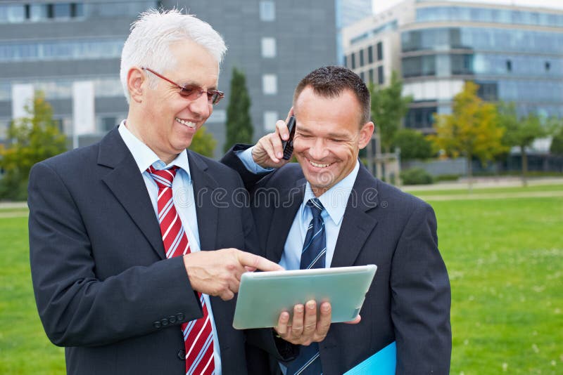 Two Business Men Working Outdoors Stock Image - Image of digital ...