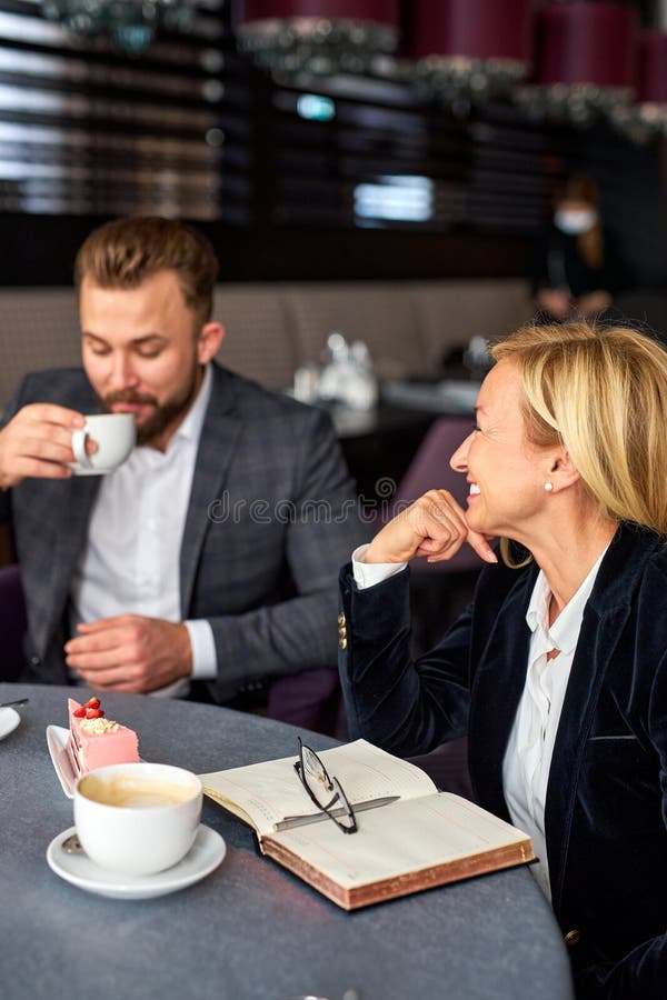 Two Business Partners Chatting Over a Cup of Coffee Stock Photo - Image ...