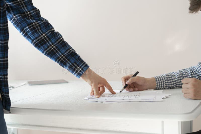 The Two Business Partners Sitting at the Table and Sign the Agreement ...