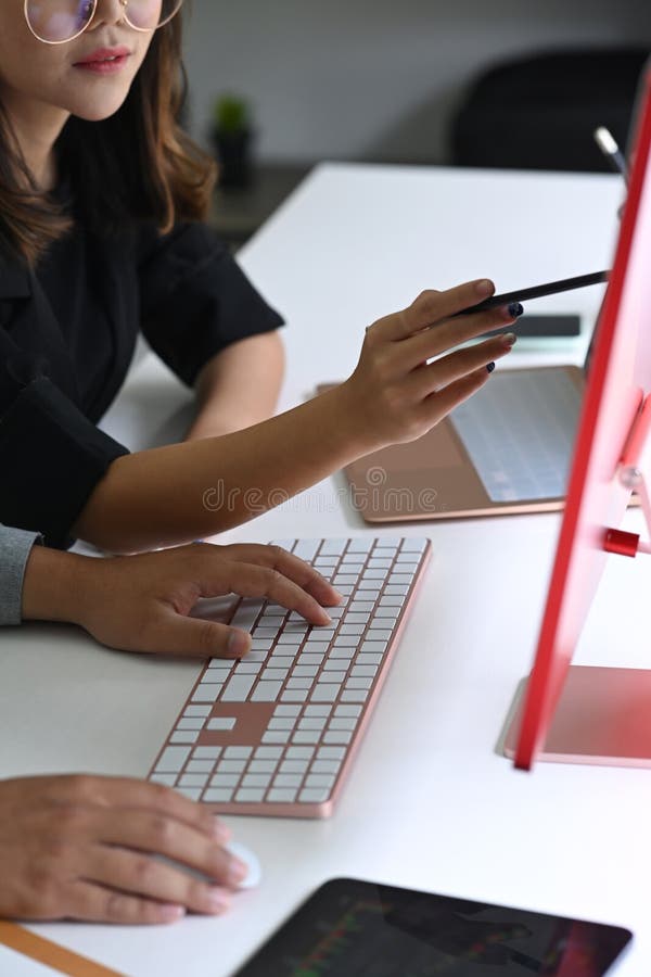 Business People Analyzing Business Data on Computer Together in Office ...