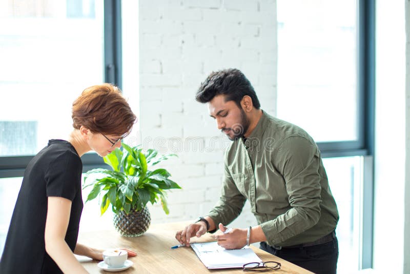 Two Business People Discuss Meeting Table with Documents and Write ...