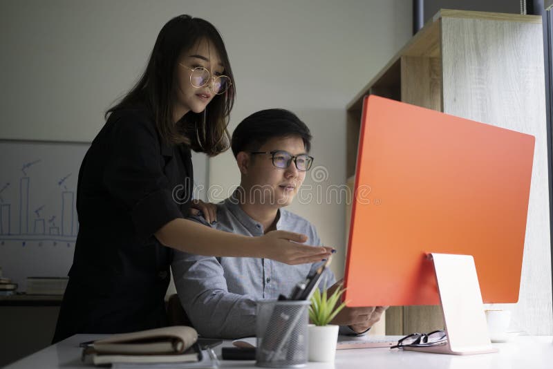Two Businesspeople Discussing Business Data Together on Computer. Stock ...