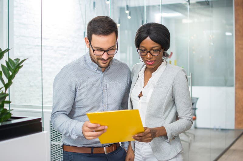 Two Business People Discussing Document in the Modern Office Stock ...