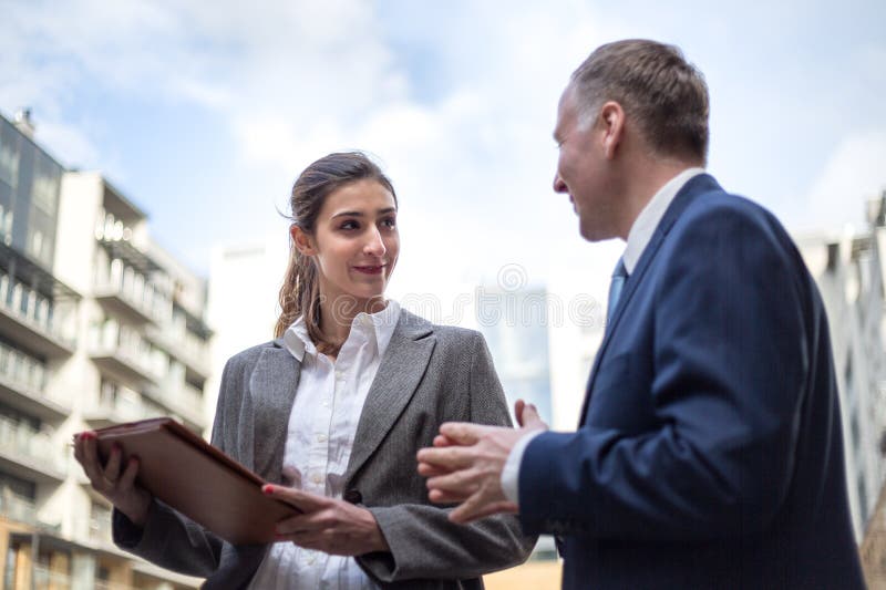 Two Business People Discussing Outside the Office Stock Photo - Image ... Two Business People Discussing Outside the Office Stock Photo - Image ...