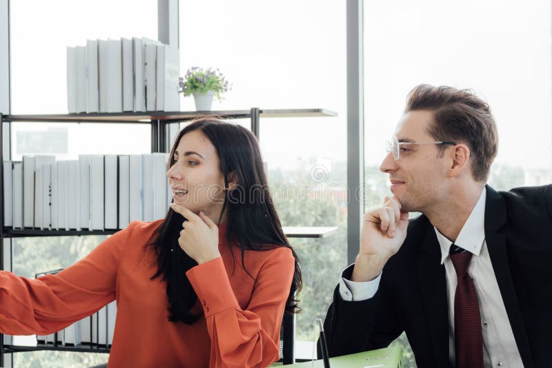Two Business People Discussing about Work in an Office Stock Photo ...