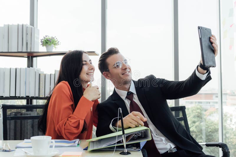 Two Business People Discussing about Work in an Office Stock Photo ...