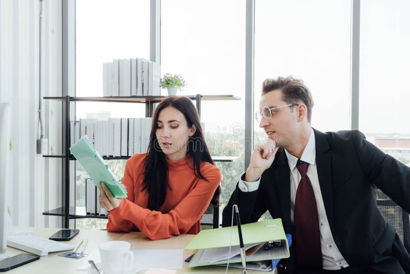 Two Business People Discussing about Work in an Office Stock Image ...