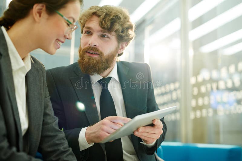 Two Business People Discussing Work in Office Stock Photo - Image of ...