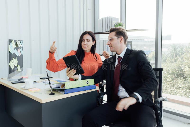 Two Business People Discussing about Work in an Office Stock Image ...