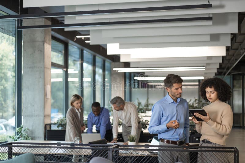 Two Business People Discussing Work Together Using a Tablet in a Modern ...