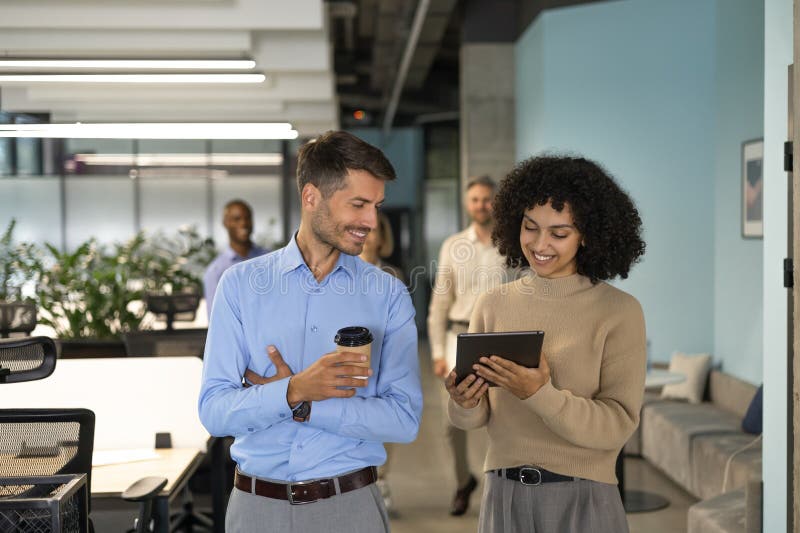 Two Business People Discussing Work Together Using a Tablet in a Modern ...