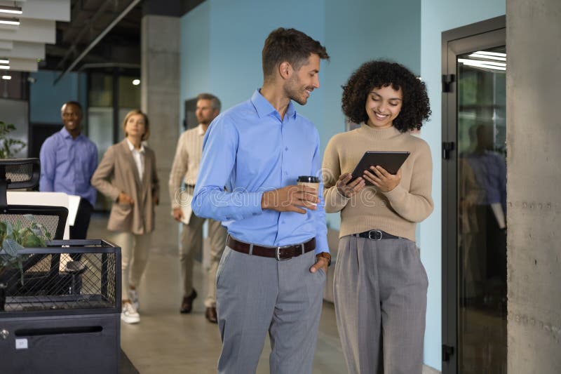 Two Business People Discussing Work Together Using a Tablet in a Modern ...