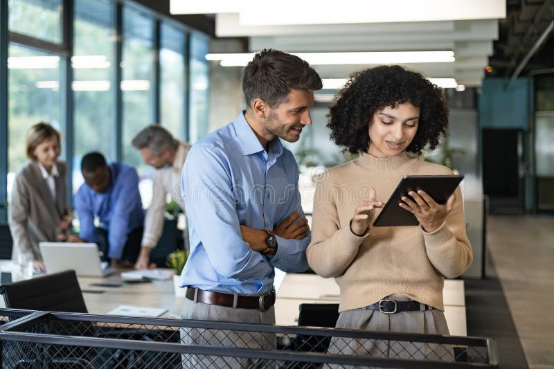 Two Business People Discussing Work Together Using a Tablet in a Modern ...