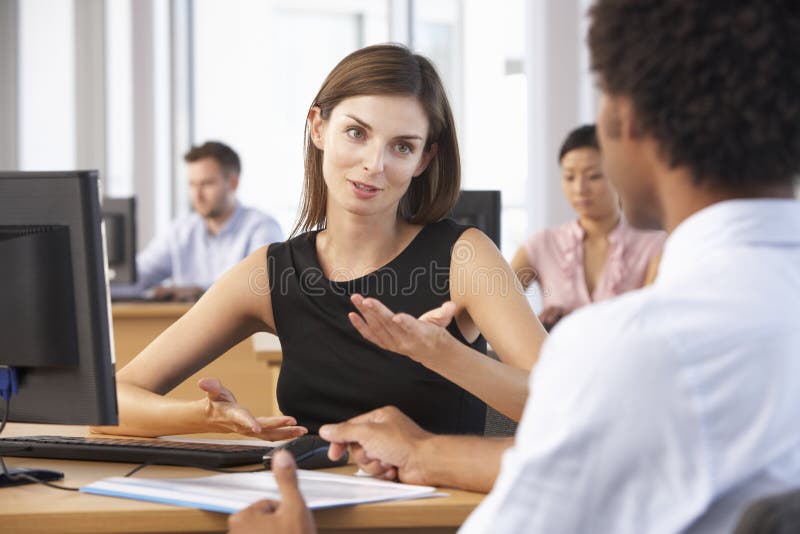 Two Business People Having Meeting in Busy Office Stock Photo - Image ...