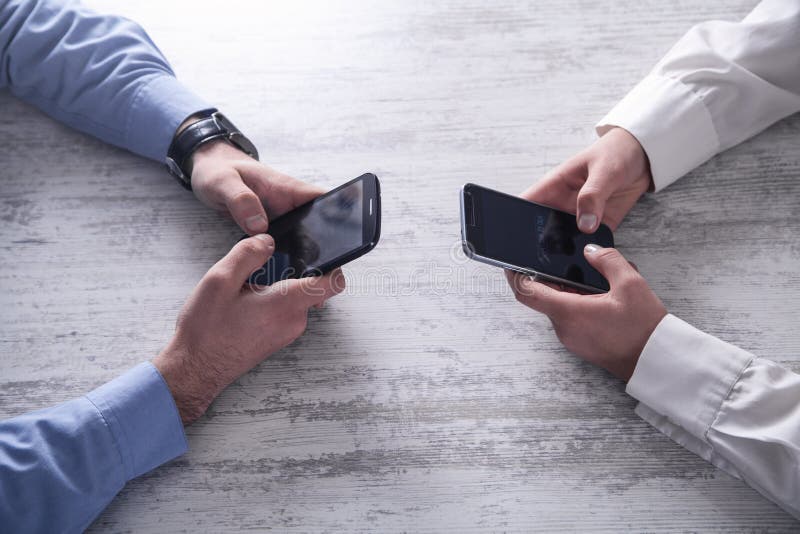 Two Business People Holding Smartphone Stock Image - Image of ...