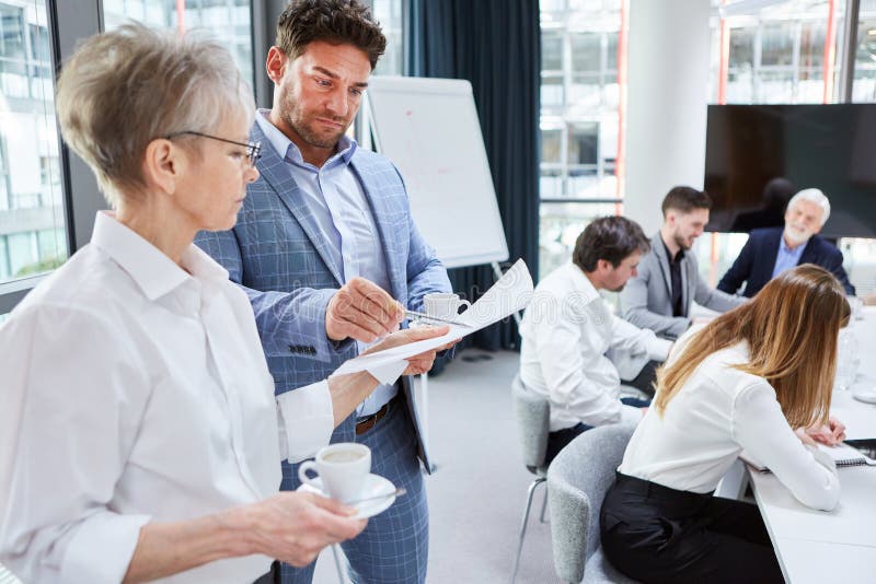 Two Business People Look at the Protocol Together Stock Image - Image ...