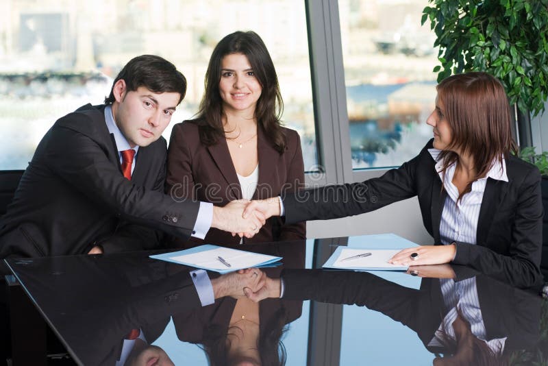 Two Business People Making a Handshake Over a Deal Stock Photo - Image ...