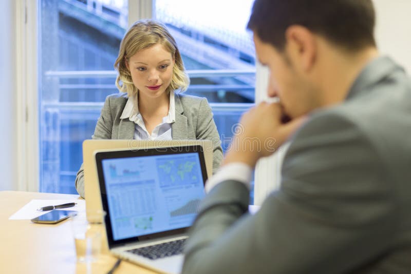Two Business People in a Office, Working on Computer Stock Image ...
