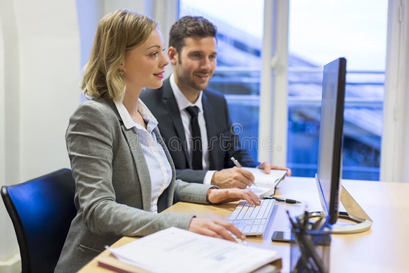 Two Business People in a Office, Working on Computer Stock Photo ...