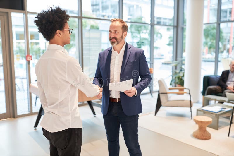 Two Business People Shaking Hands in Greeting Stock Photo - Image of ...