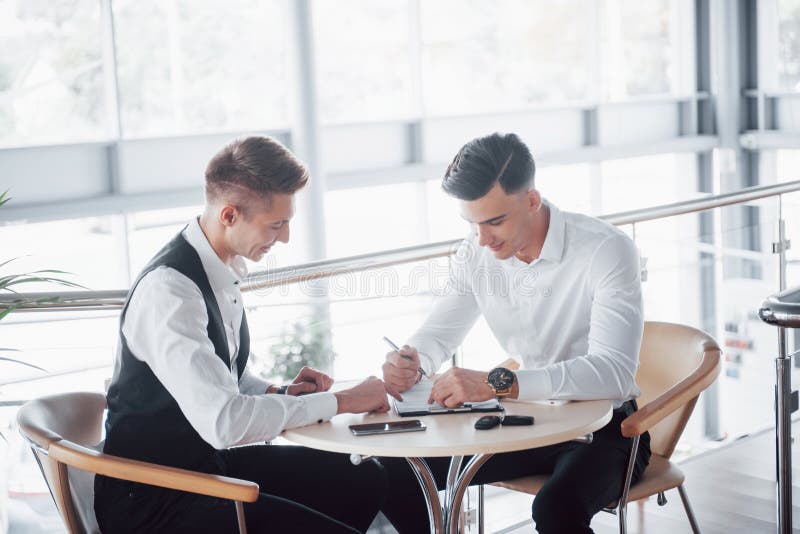 Two Business People Sign Documents in a Large, Spacious Office Stock ...