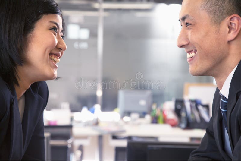 Two Business People Smiling and Laughing Face To Face Stock Image ...