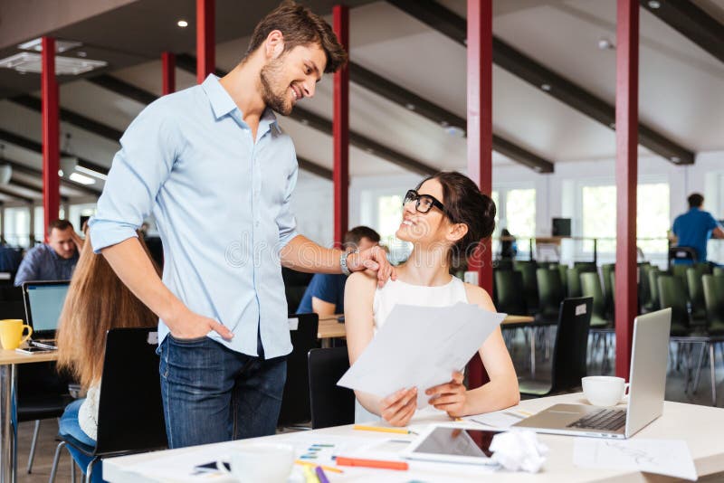 Two Business People Smiling and Working Together Stock Image - Image of ...
