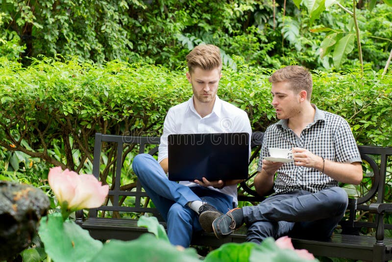 Two Business People Use of the Notebook Computer at Outdoor Stock Photo ...