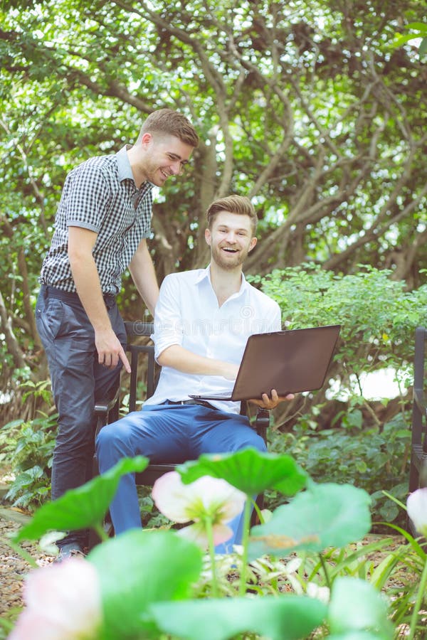 Two Business People Use of the Notebook Computer at Outdoor. Stock ...