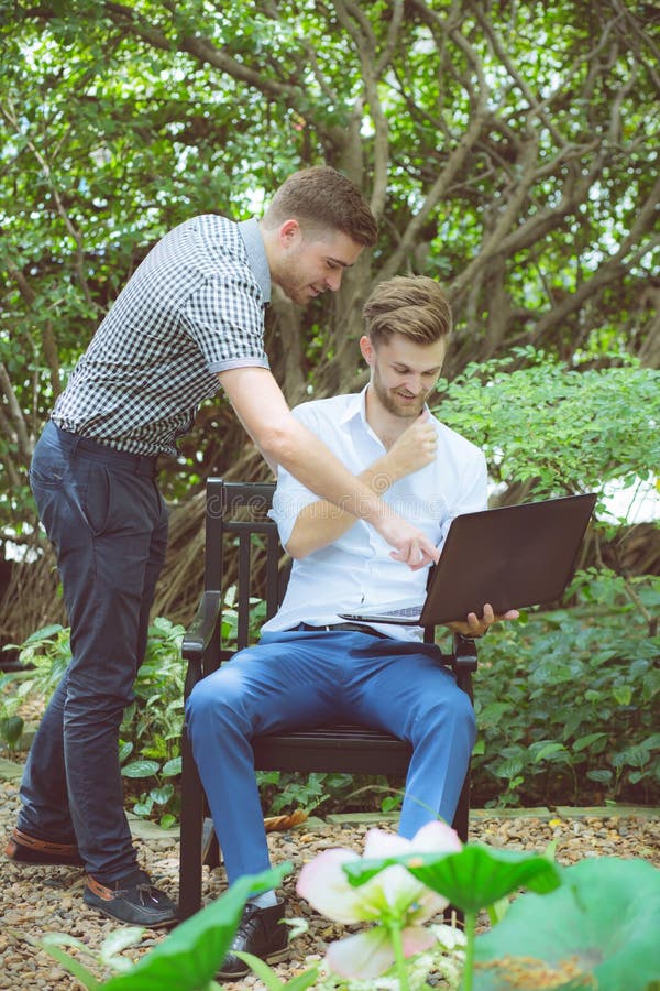 Two Business People Use of the Notebook Computer at Outdoor. Stock ...