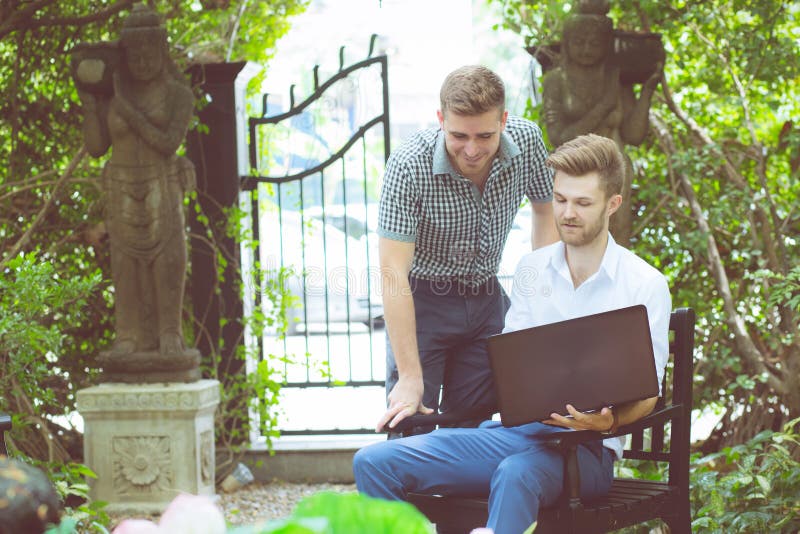 Two Business People Use of the Notebook Computer at Outdoor. Stock ...