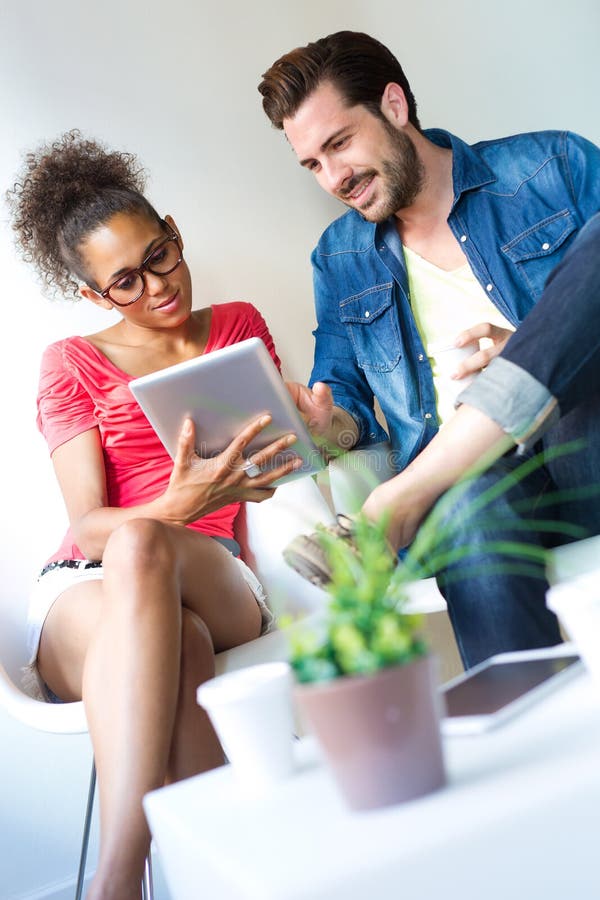 Two Business People Using a Digital Tablet at Office. Stock Photo ...