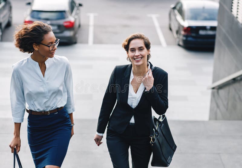 Two Business People Walking Up the Steps Stock Image - Image of ...