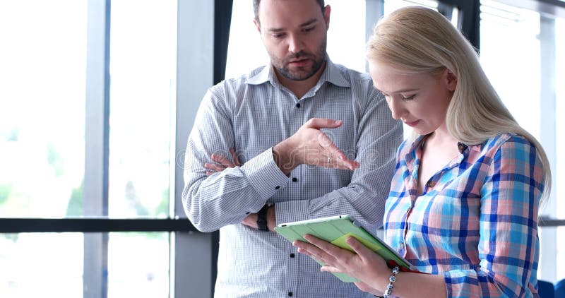 Two Business People Working with Tablet in Startup Office Stock Image ...
