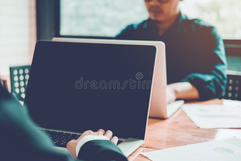 Two Business People Working Together on Laptop Meeting with Tech Stock ...