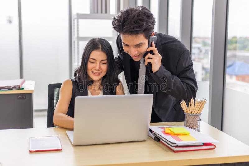 Two Business People Working Together with Smile on Face Using Laptop at ...