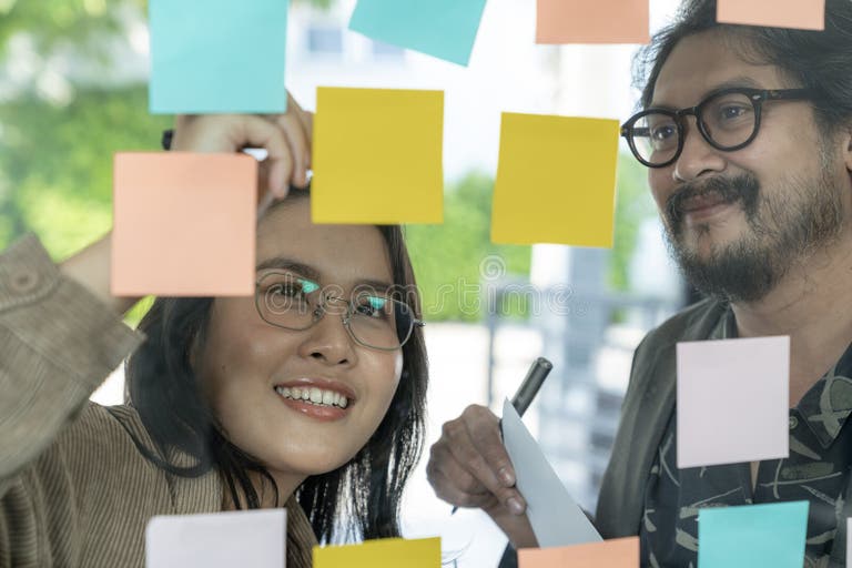 Two Business People Writing Business Idea into Sticky Note Stock Photo ...