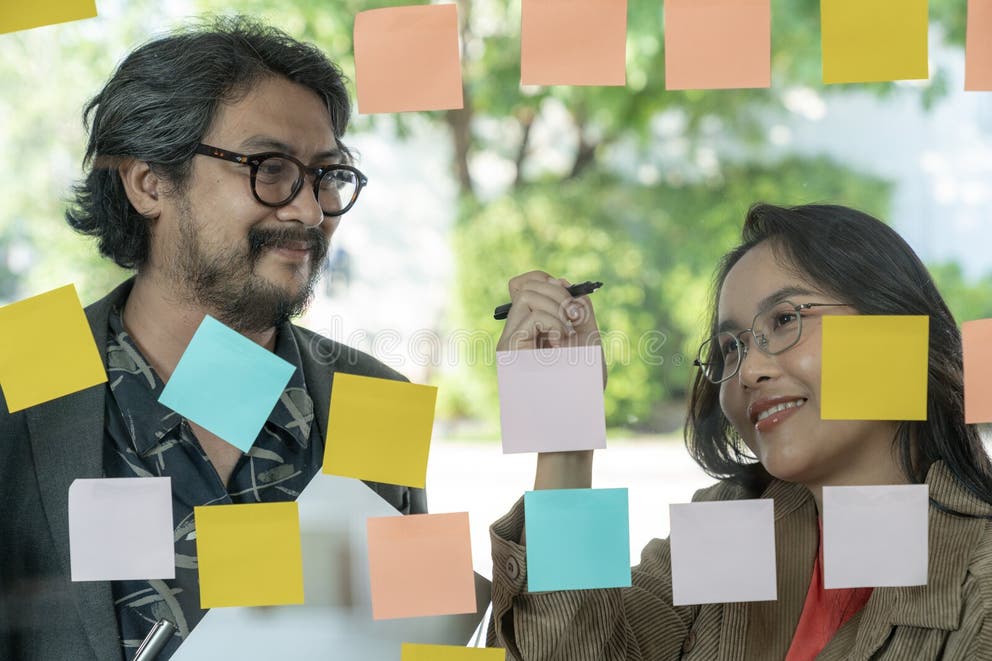 Two Business People Writing Business Idea into Sticky Note Stock Photo ...