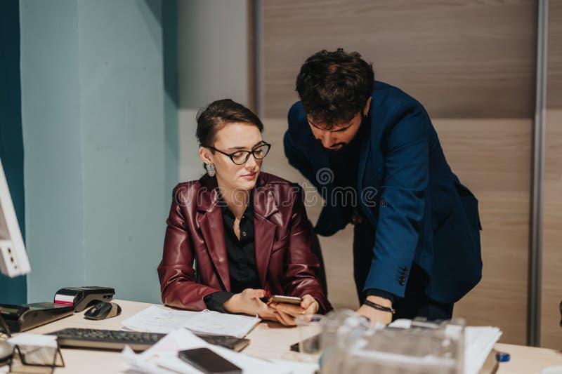 Business Colleagues Discussing Work at a Desk in a Modern Office Stock ...