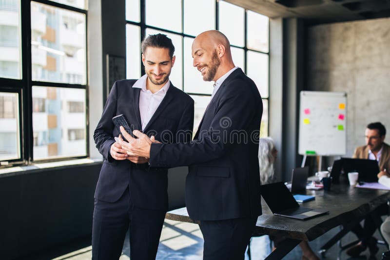 Two Business Professionals Discussing a Project in a Modern Office ...