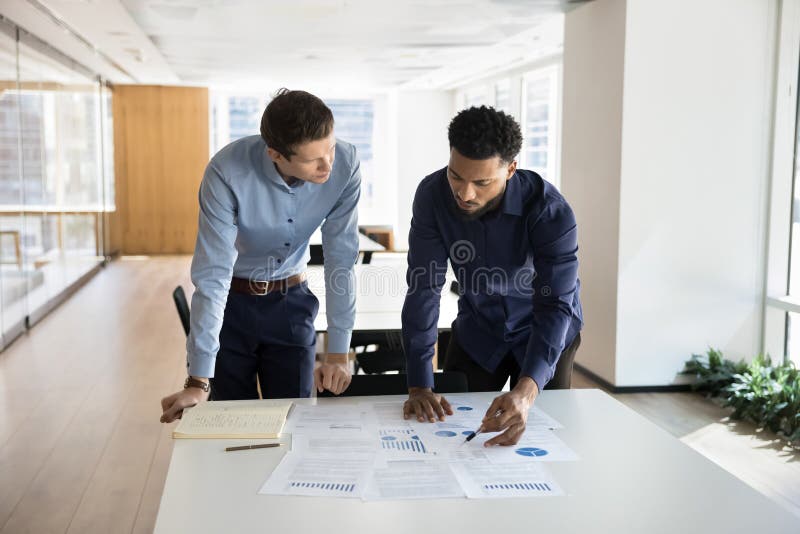 Two Business Professionals Engaged in Financial Documents Analysis ...