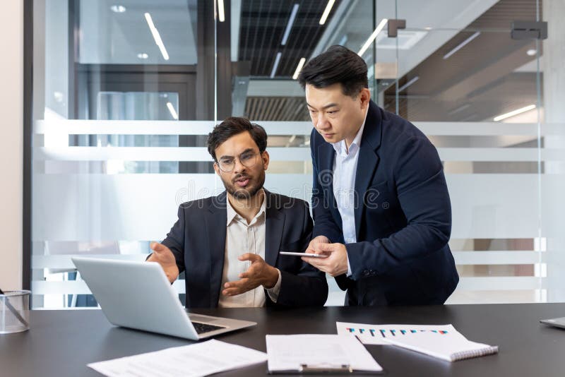 Two Business Professionals in a Modern Office Setting Analyzing Data on ...