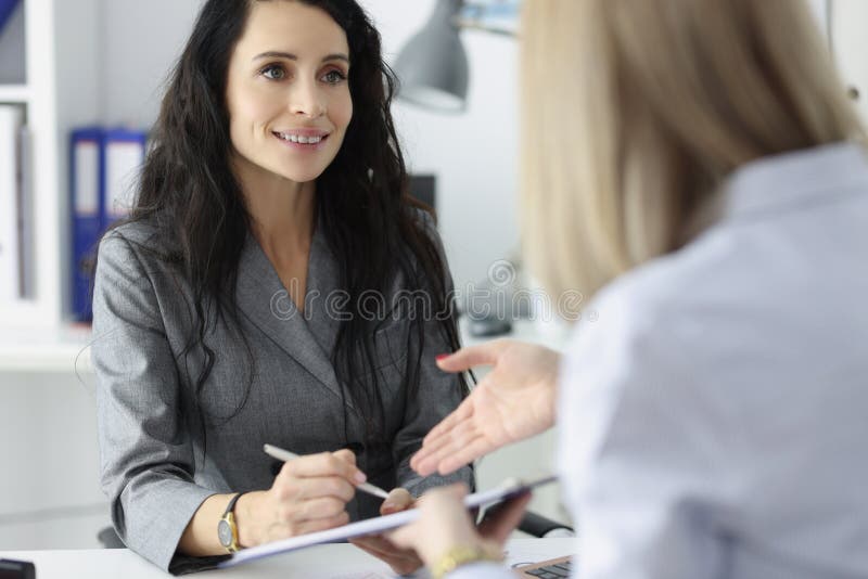Two Business Women Discussing at Table in Office Stock Image - Image of ...