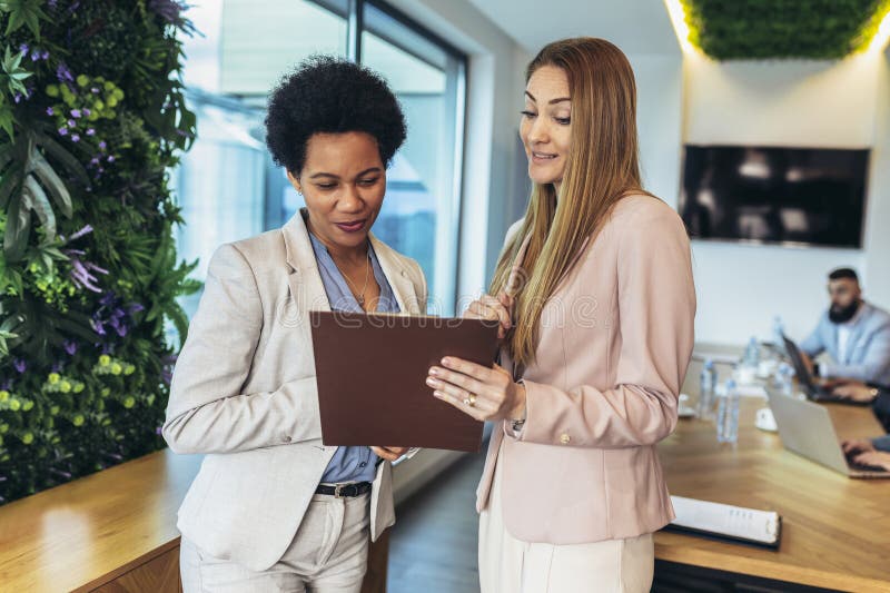 Business Women Having a Discussion, they Re Standing in the Office ...