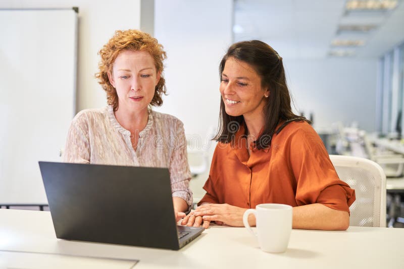 Two Business Women Working Together on Laptop Computer Stock Image ...