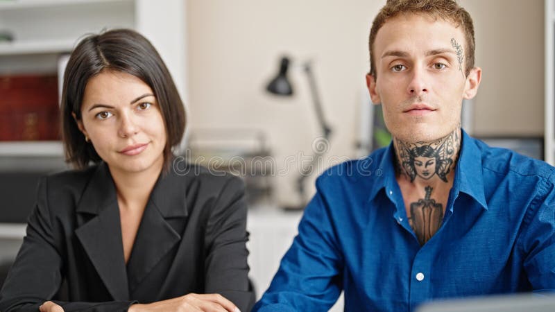 Two Business Workers Sitting on Table with Serious Face at the Office ...